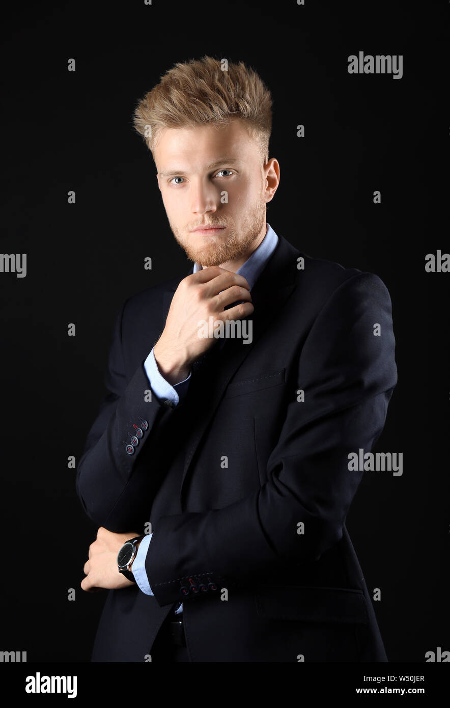 Stylish young man in formal clothes on dark background Stock Photo - Alamy