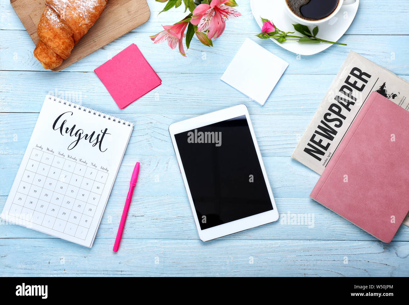 Modern tablet computer with calendar, newspaper and stationery on ...