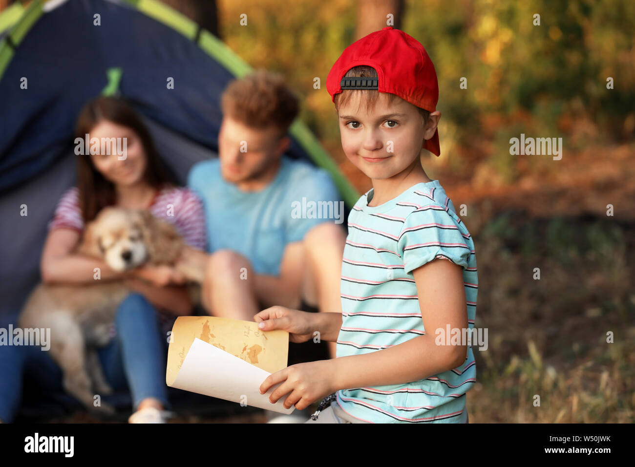 Little boy with map in camp Stock Photo - Alamy