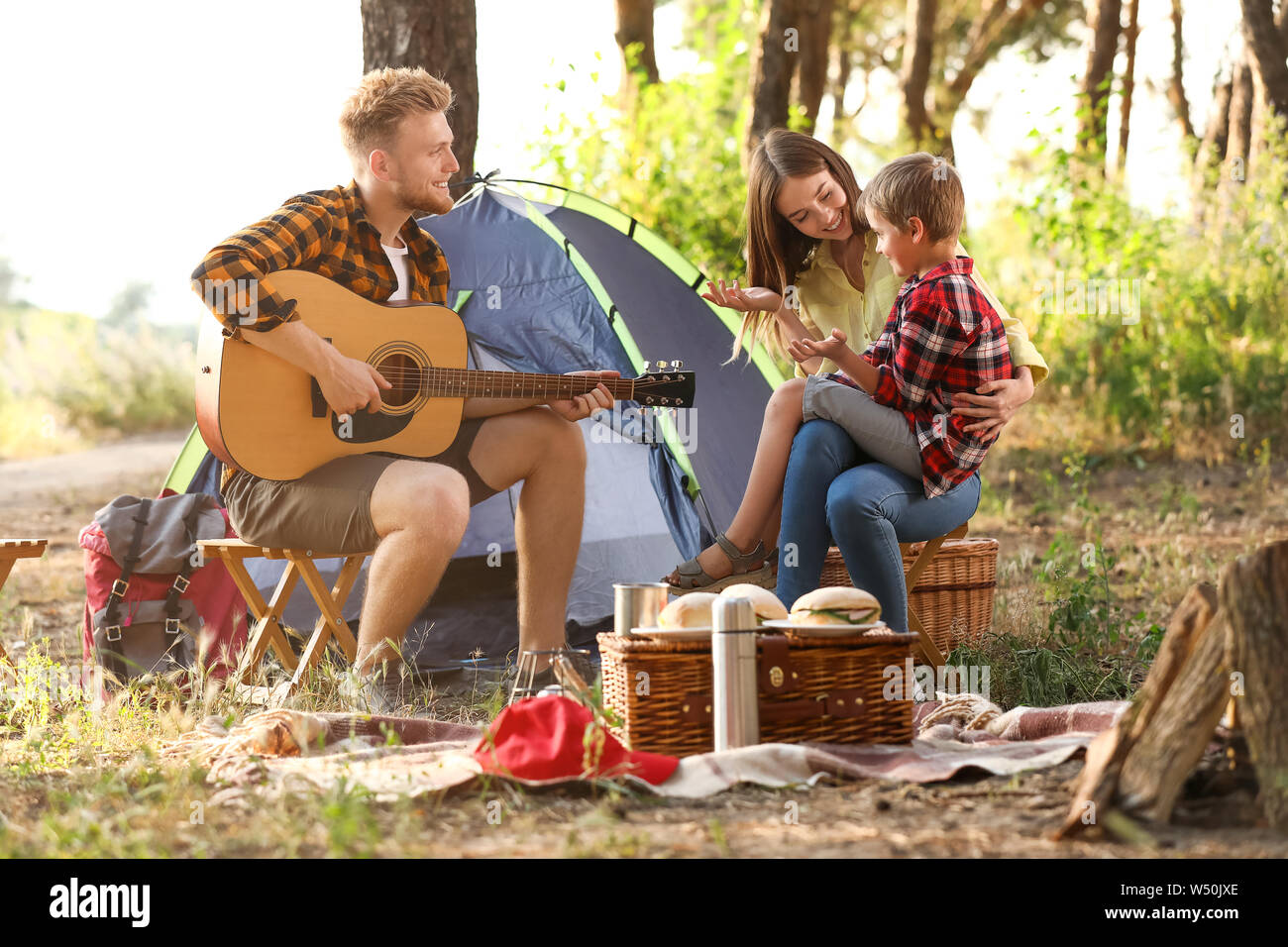 Happy family spending weekend in forest Stock Photo - Alamy
