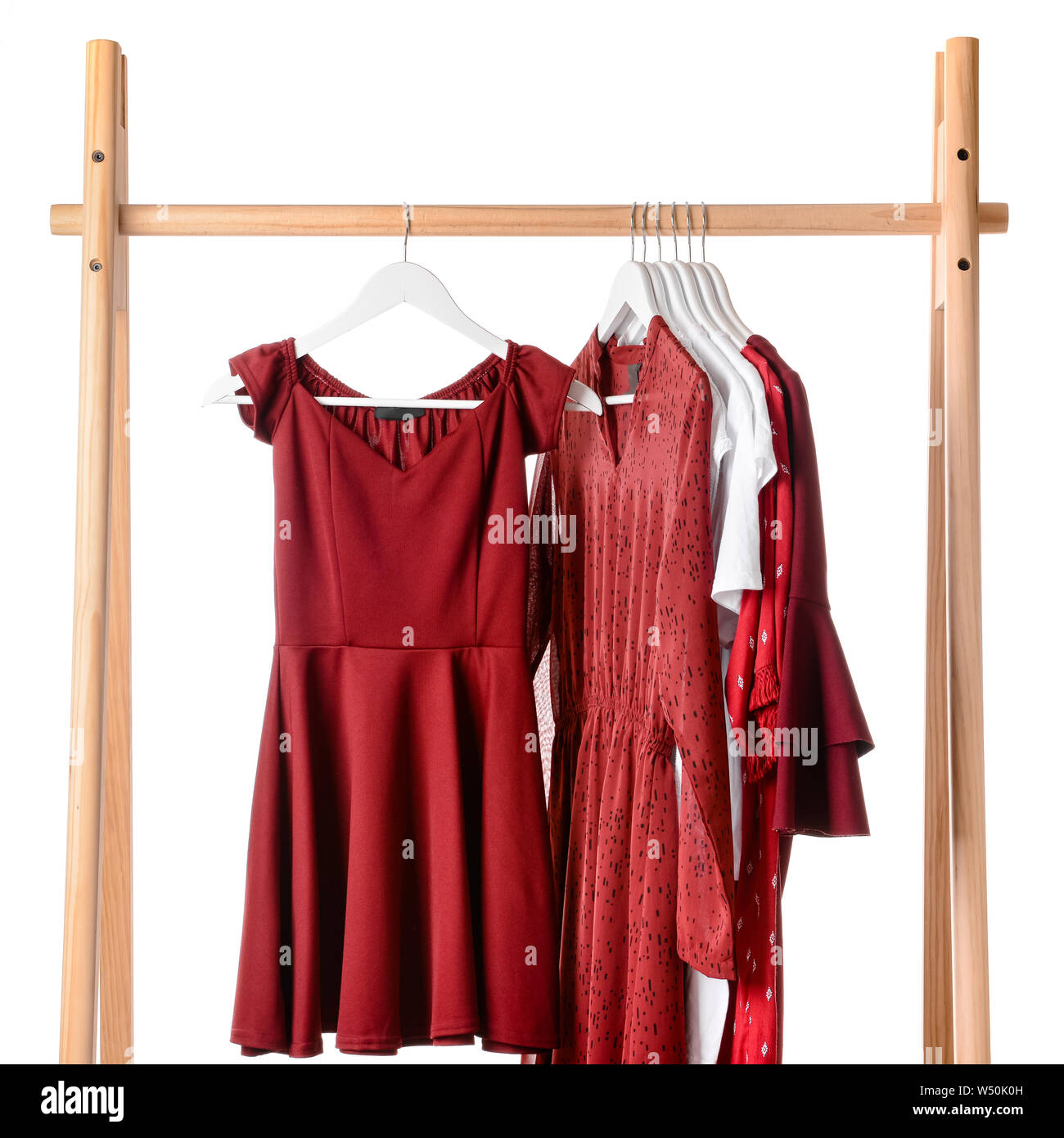 Rack with hanging clothes on white background Stock Photo - Alamy