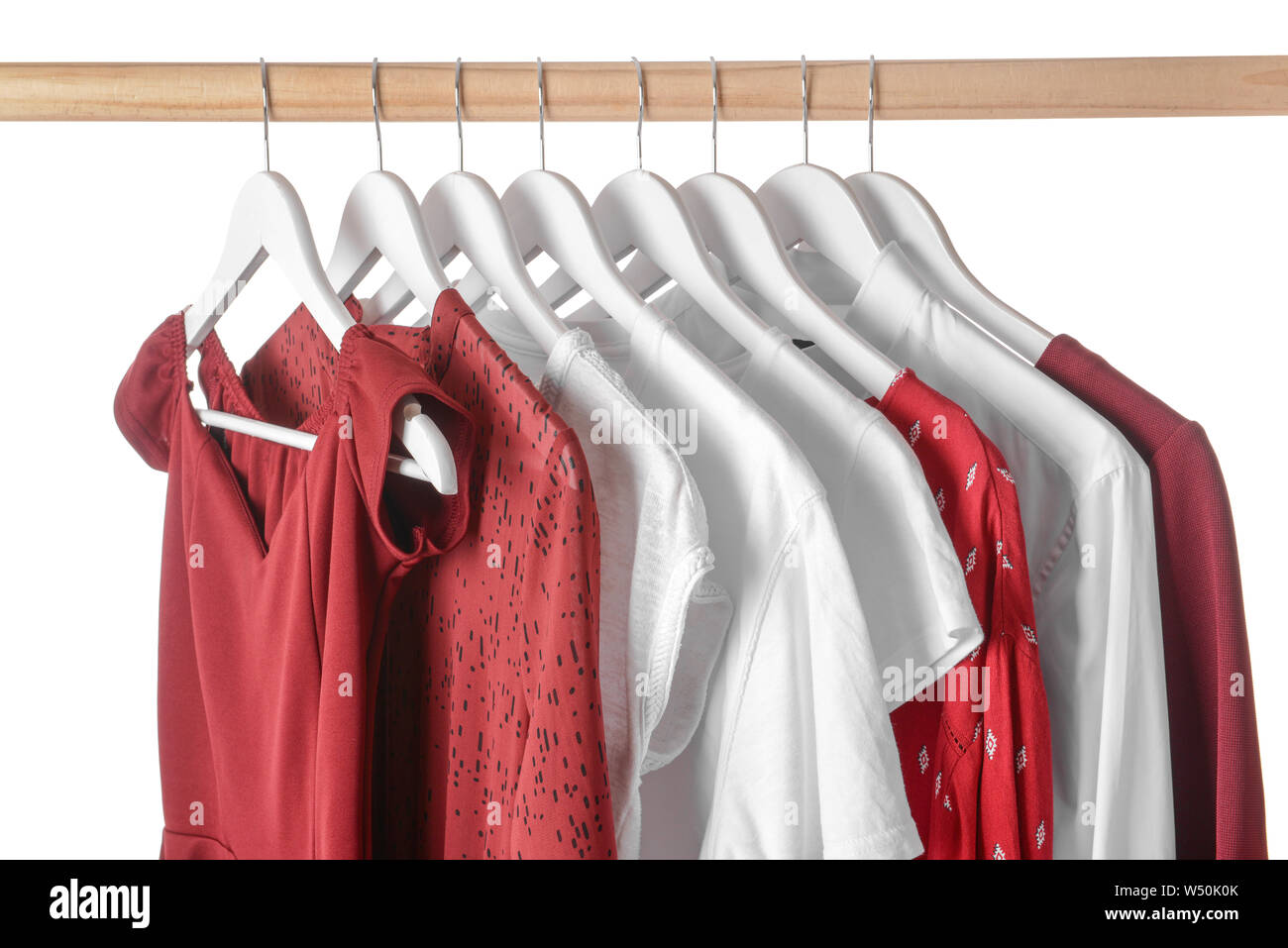 Rack with hanging clothes on white background Stock Photo - Alamy