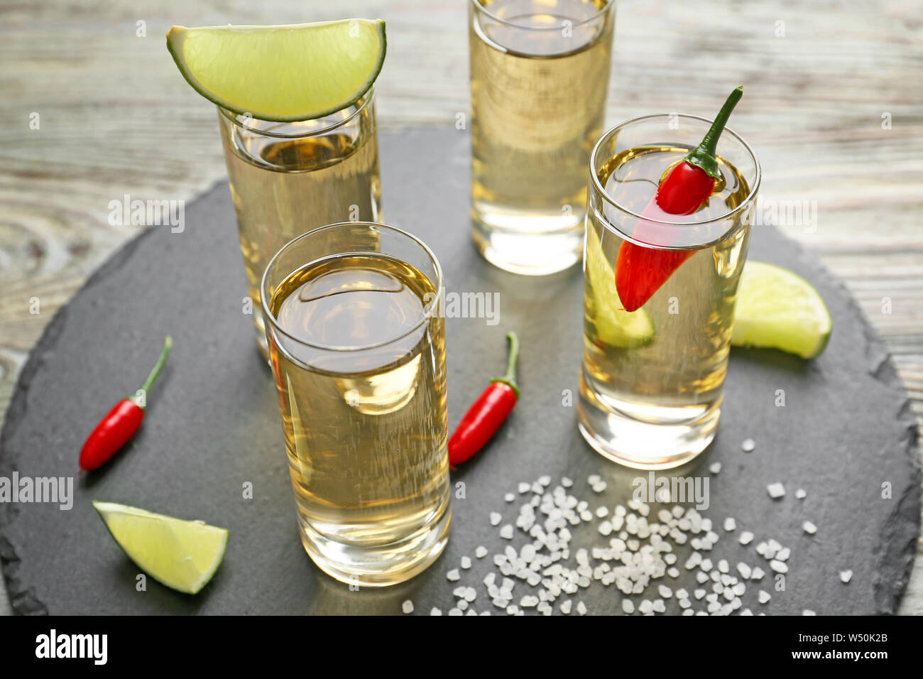 Shots of tequila on slate plate Stock Photo - Alamy