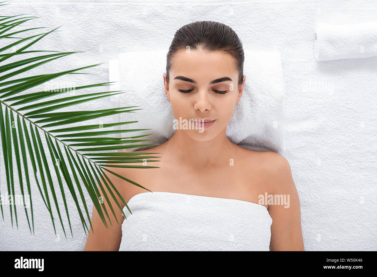 Beautiful young woman relaxing in spa salon Stock Photo - Alamy