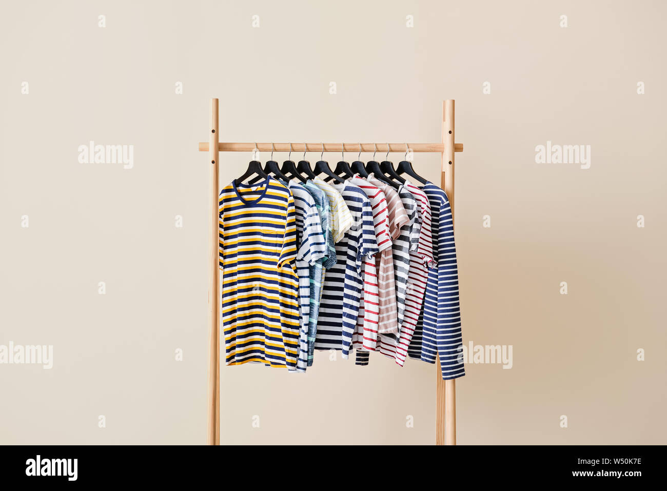 Rack with hanging clothes on color background Stock Photo - Alamy