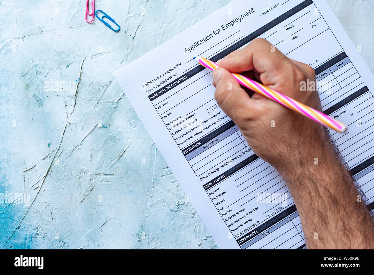 Hand filling Standard Application for Employment. HR, Hiring, Applicant ...