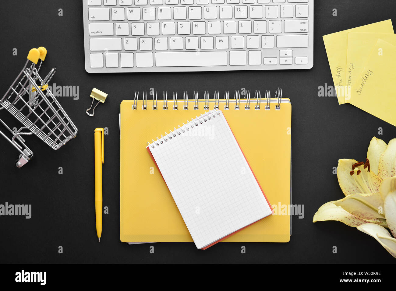Composition with stationery and computer keyboard on dark background ...