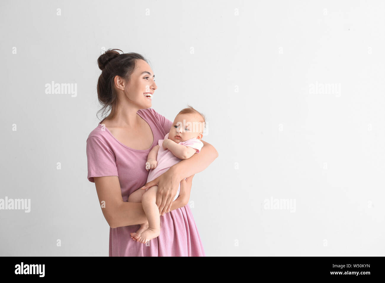 Happy mother with cute little on white background Stock Photo - Alamy