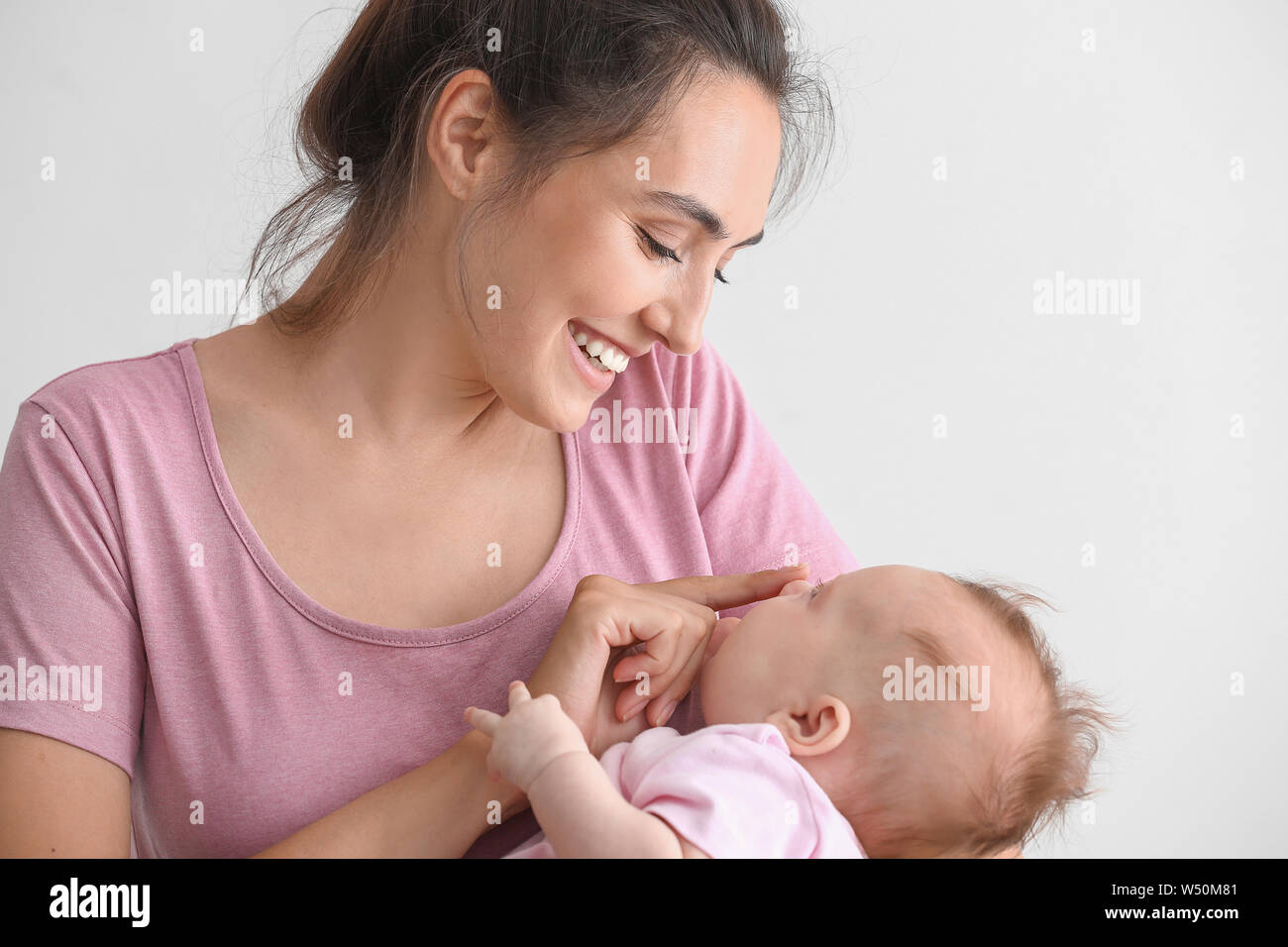 Happy mother with cute little on white background Stock Photo - Alamy