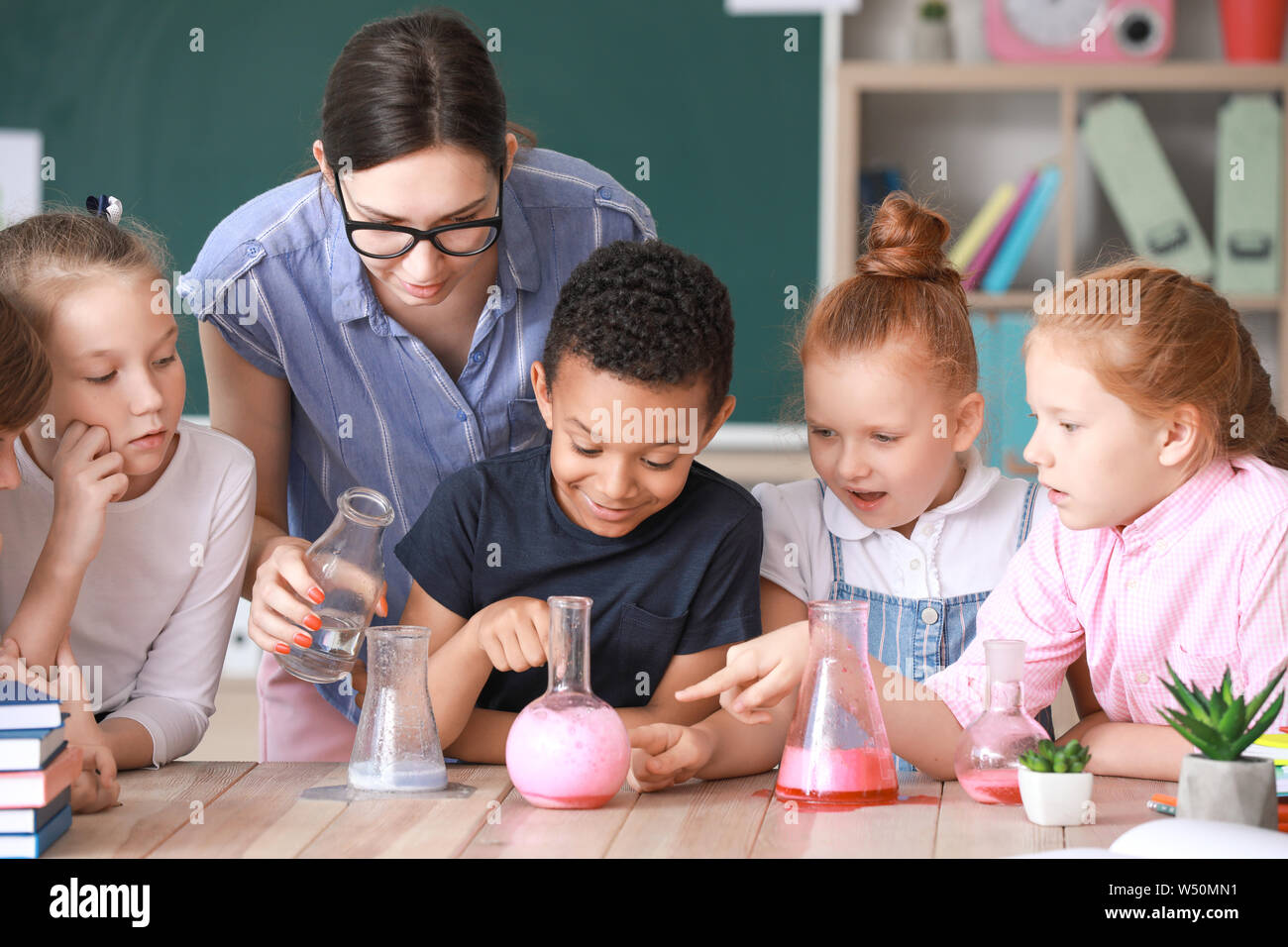 Teacher conducting chemistry lesson in classroom Stock Photo - Alamy