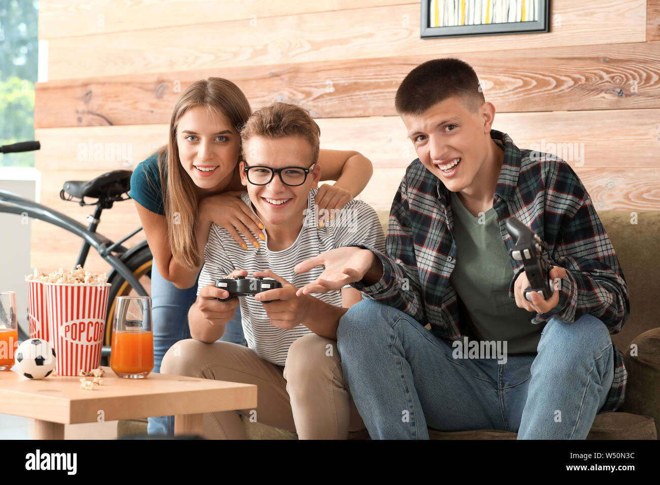 Teenagers playing video game at home Stock Photo - Alamy