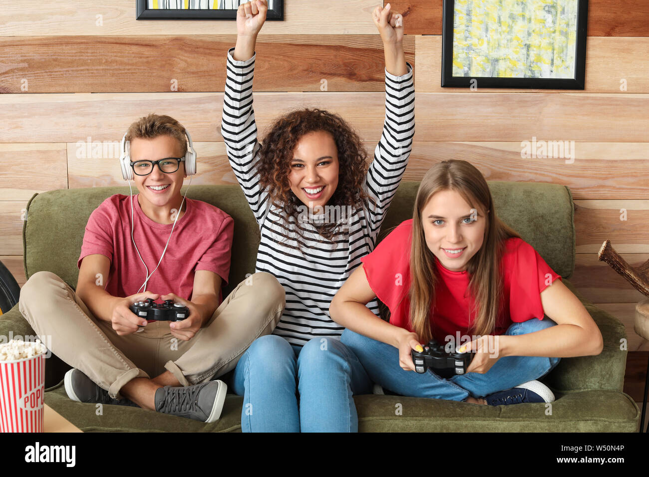 Teenagers playing video game at home Stock Photo - Alamy