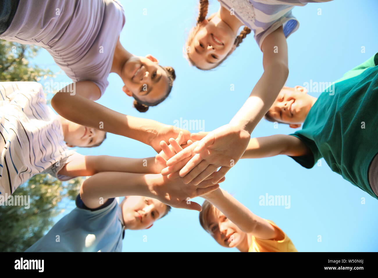 Group of children putting hands together outdoors, bottom view Stock ...