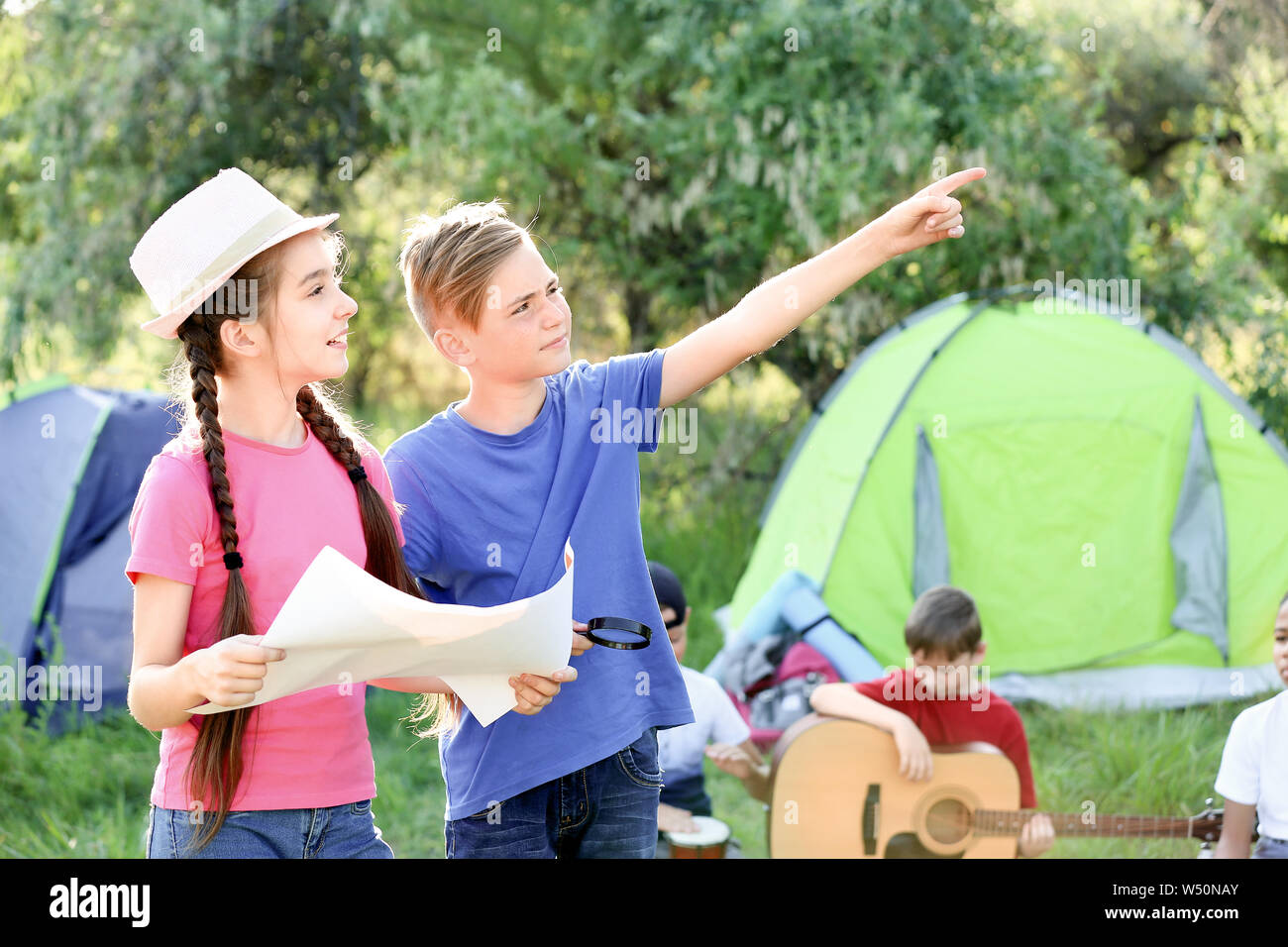 Little children with map resting at summer camp Stock Photo - Alamy