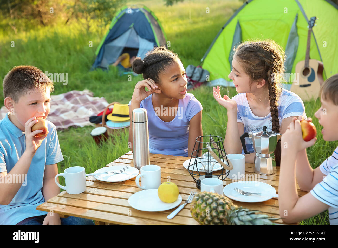 Group of children having picnic outdoors on summer day Stock Photo - Alamy