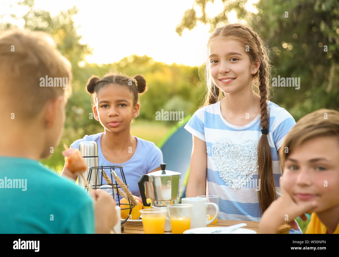 Group of children having picnic on summer day Stock Photo - Alamy