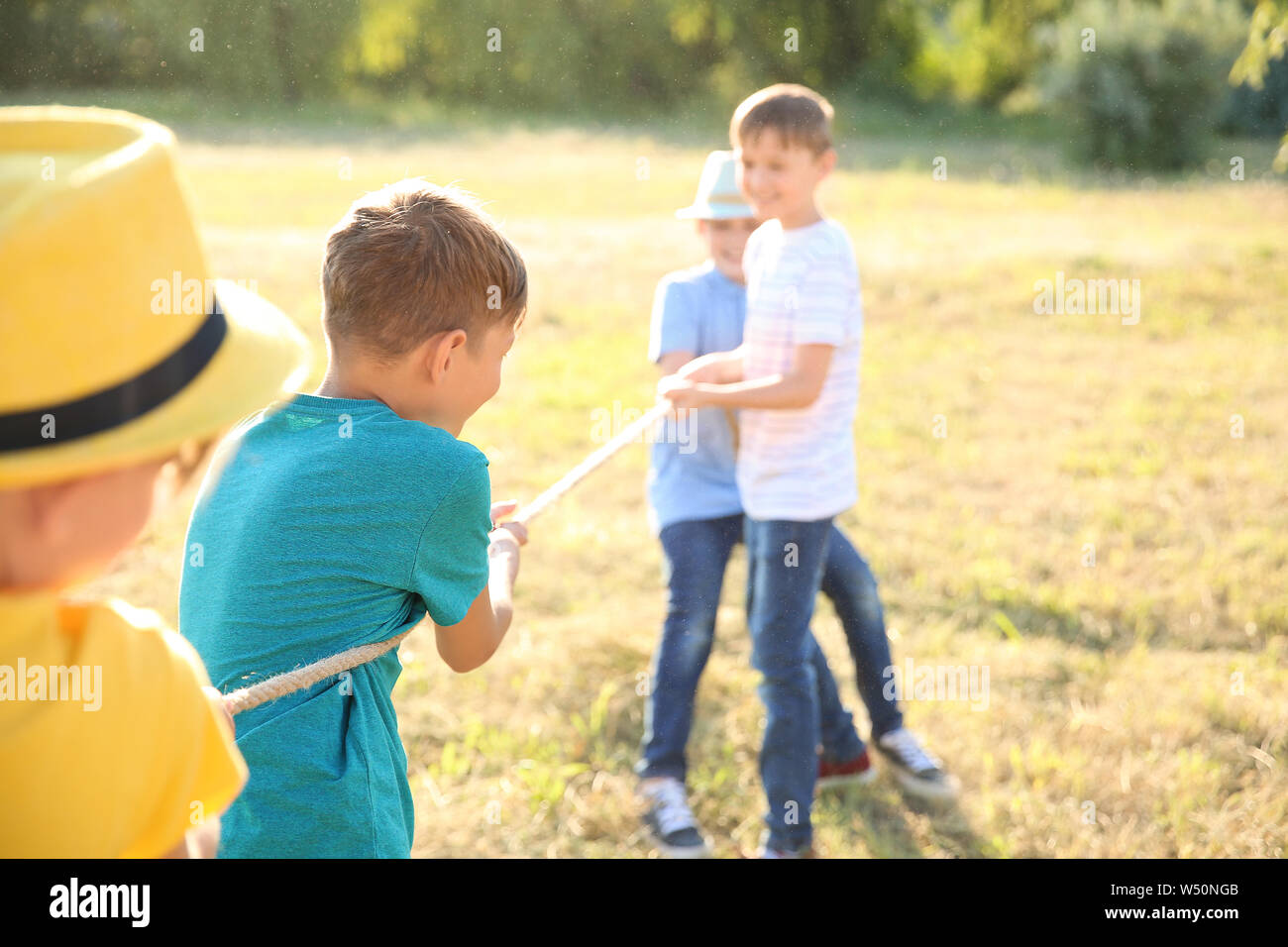 Group of children pulling rope at summer camp Stock Photo - Alamy