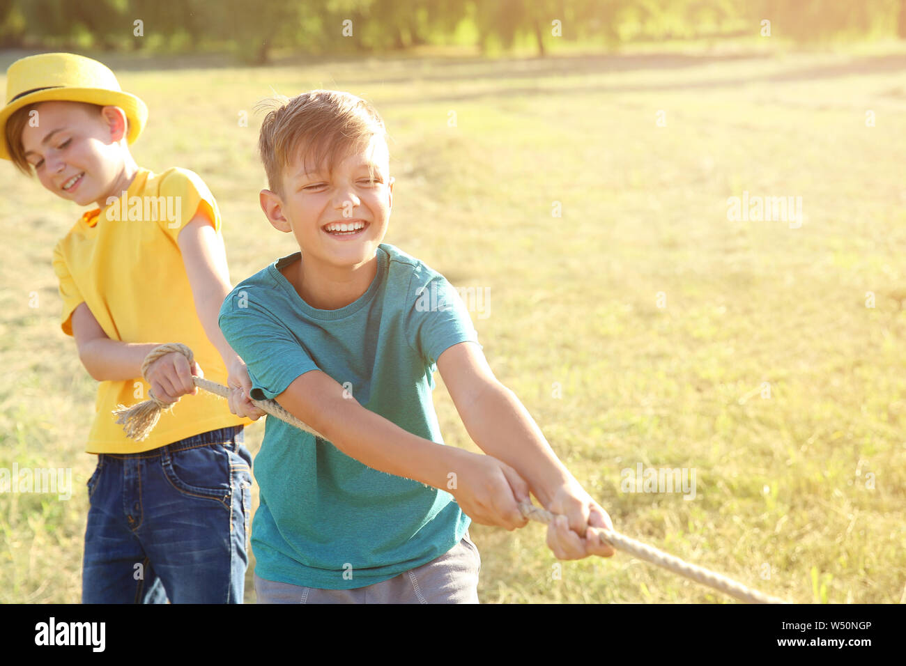 Group of children pulling rope at summer camp Stock Photo - Alamy