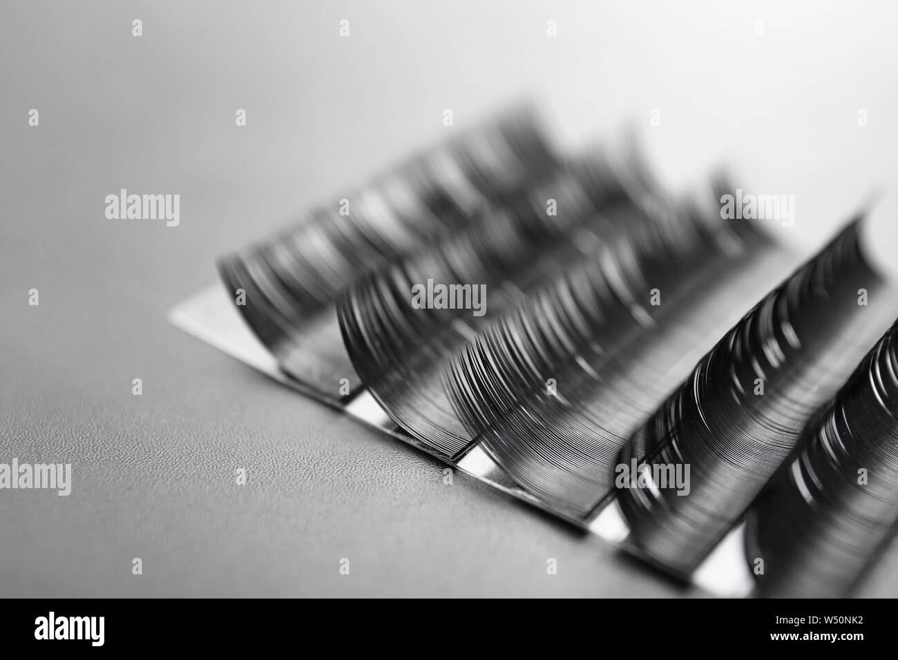 Set of eyelash extensions on grey background, closeup Stock Photo - Alamy