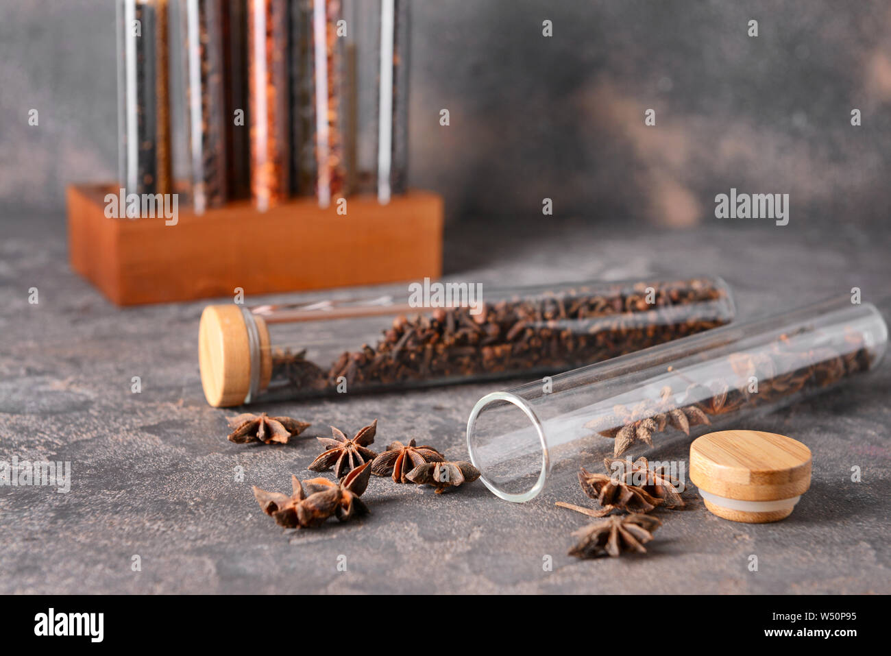 Dry anise and cloves in tubes on grey background Stock Photo - Alamy