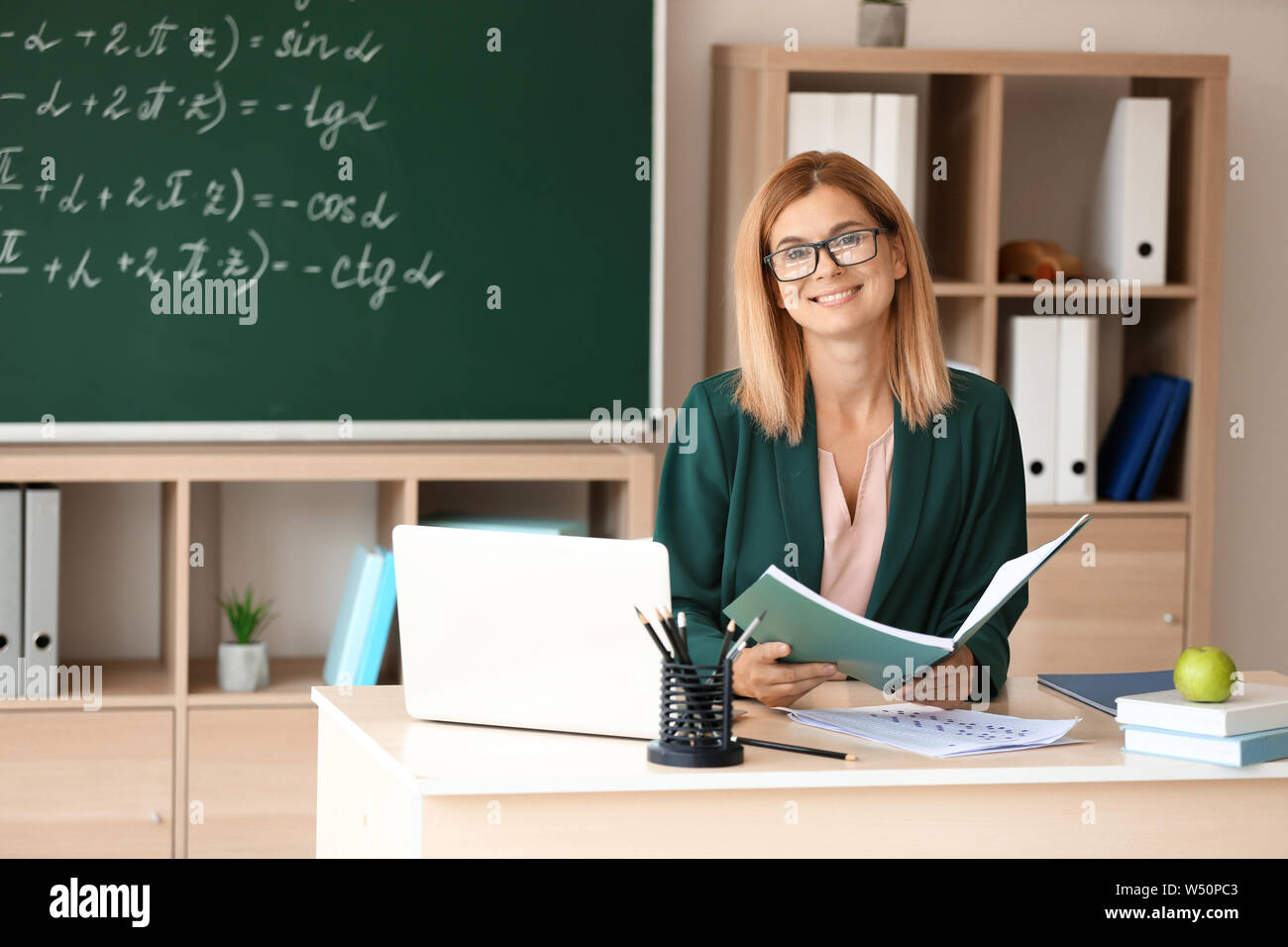 Beautiful female teacher in classroom Stock Photo - Alamy