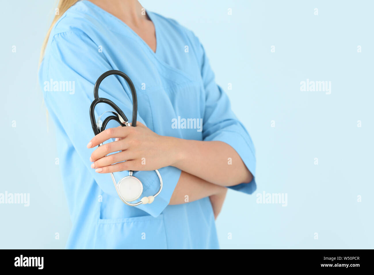 Female nurse with stethoscope on color background, closeup Stock Photo ...