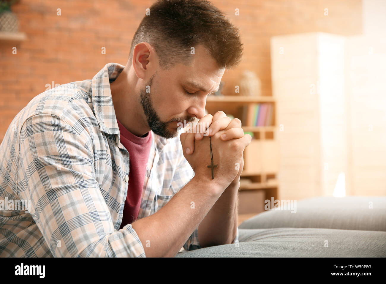 Religious man praying at home Stock Photo - Alamy
