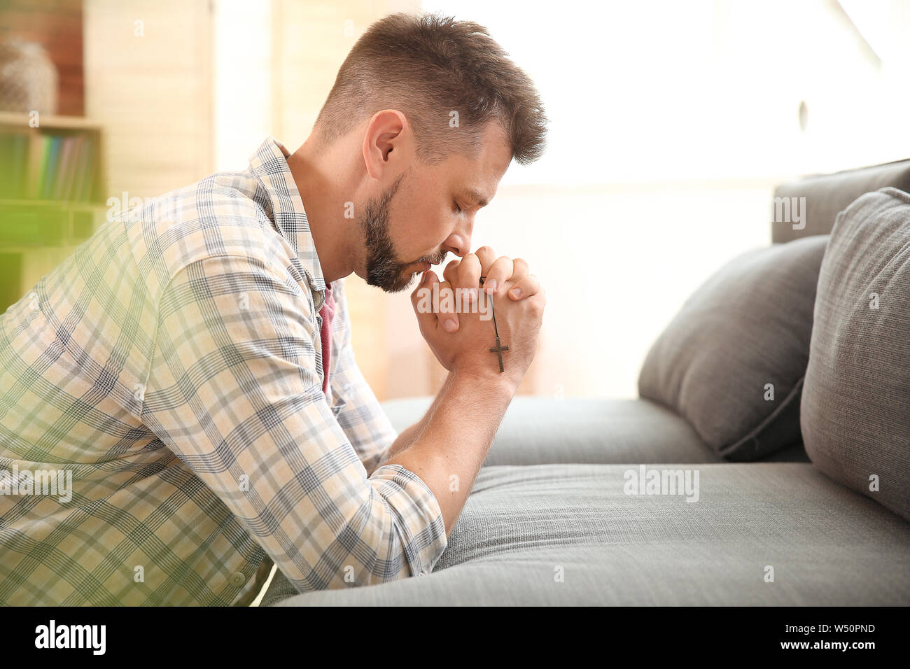 Religious man praying at home Stock Photo - Alamy