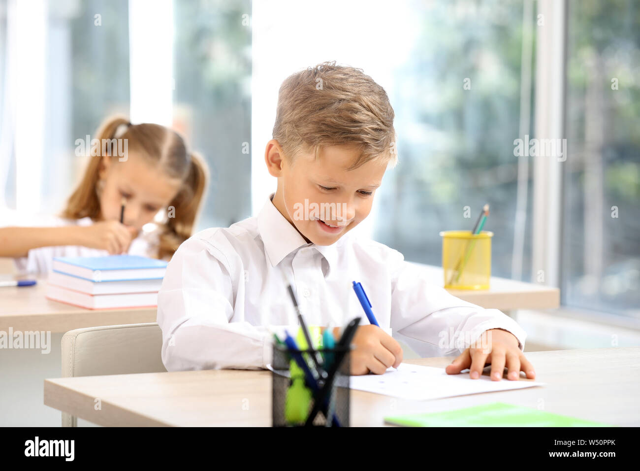Pupil passing school test in classroom Stock Photo - Alamy