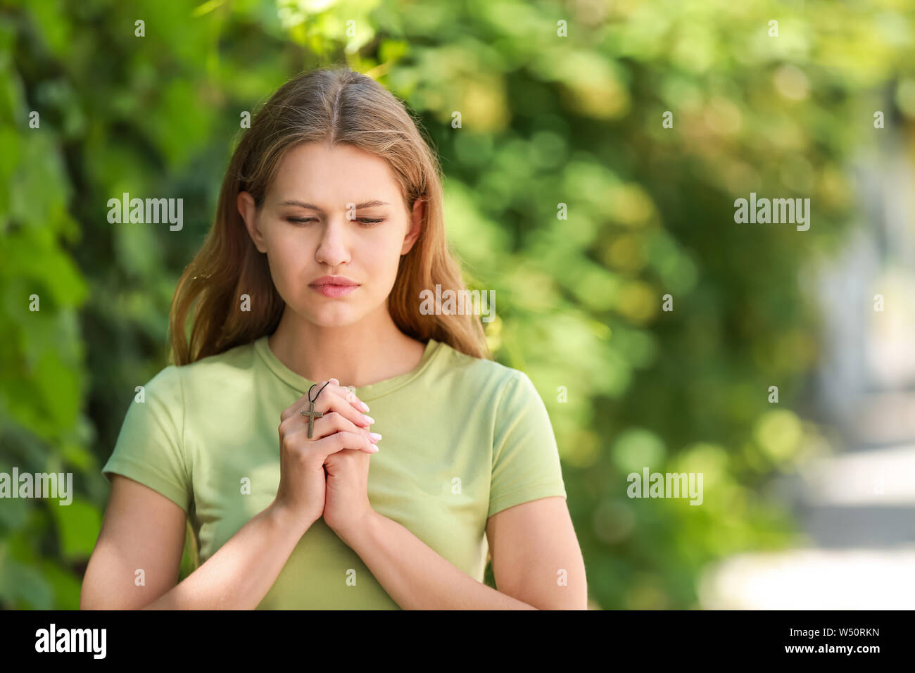 Religious woman praying to God outdoors Stock Photo - Alamy