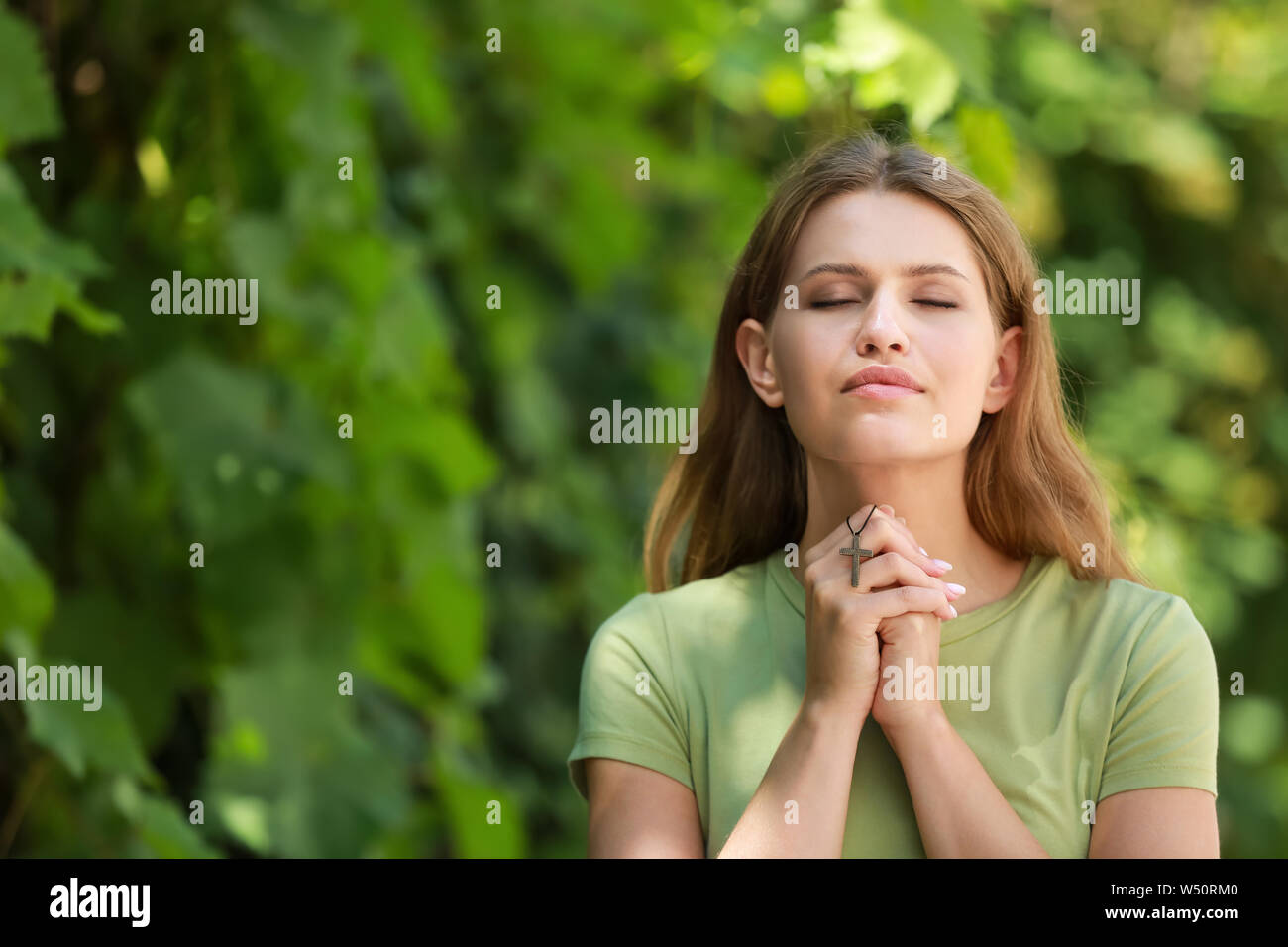 Religious woman praying to God outdoors Stock Photo - Alamy