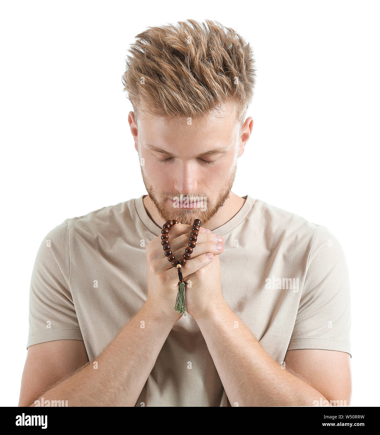 Religious young man praying to God on white background Stock Photo - Alamy