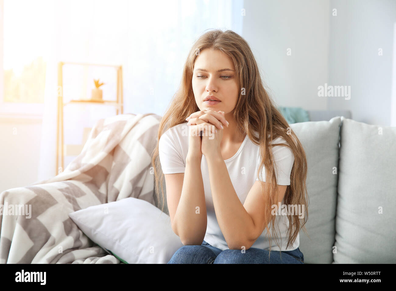 Religious young woman praying to God at home Stock Photo - Alamy