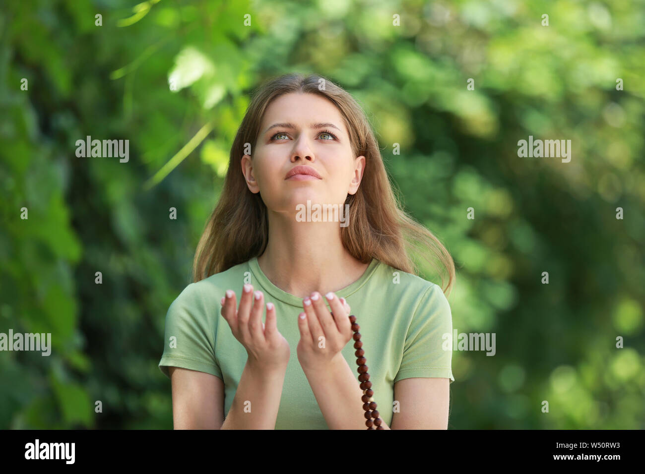 Religious woman praying to God outdoors Stock Photo - Alamy