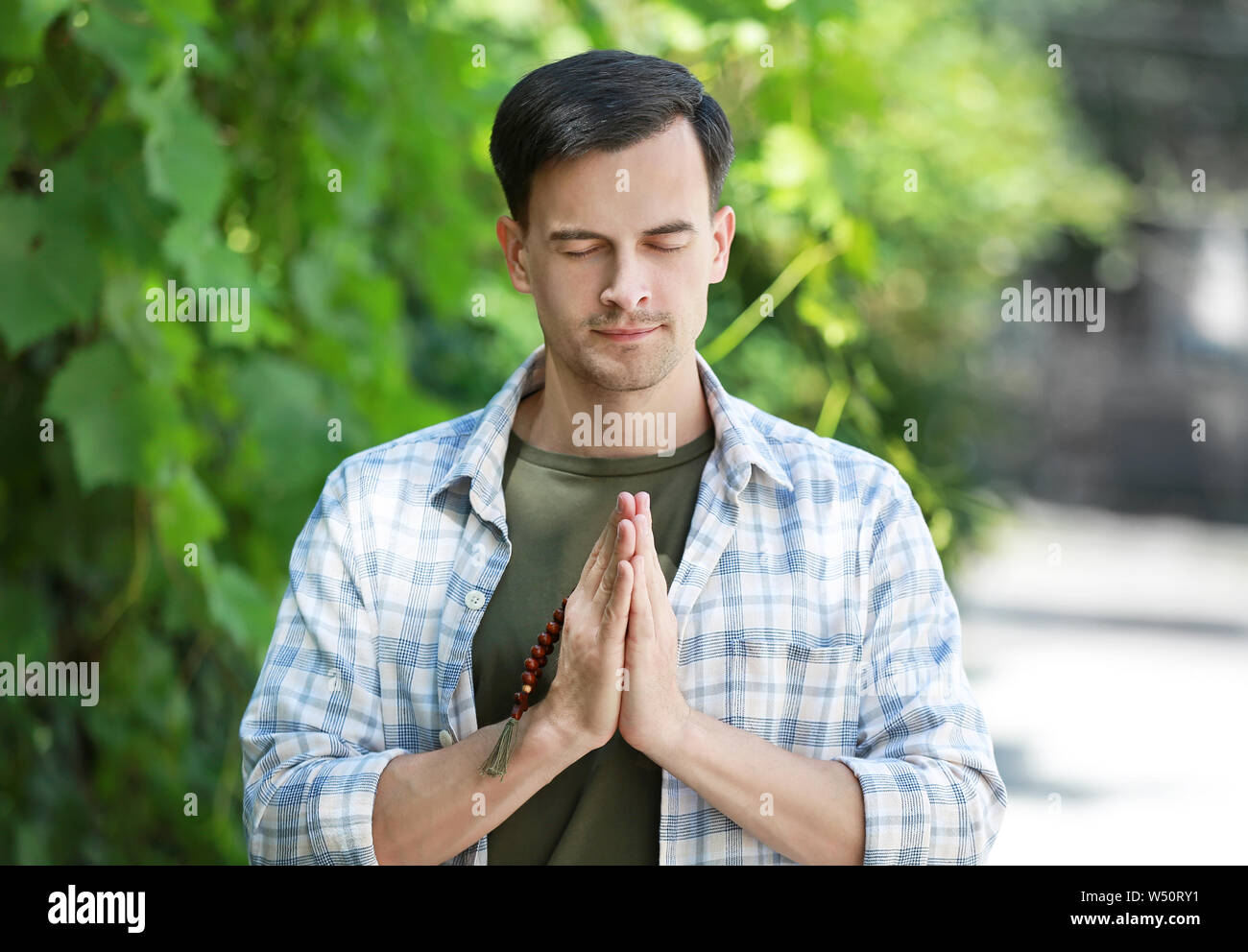 Religious man praying to God outdoors Stock Photo - Alamy