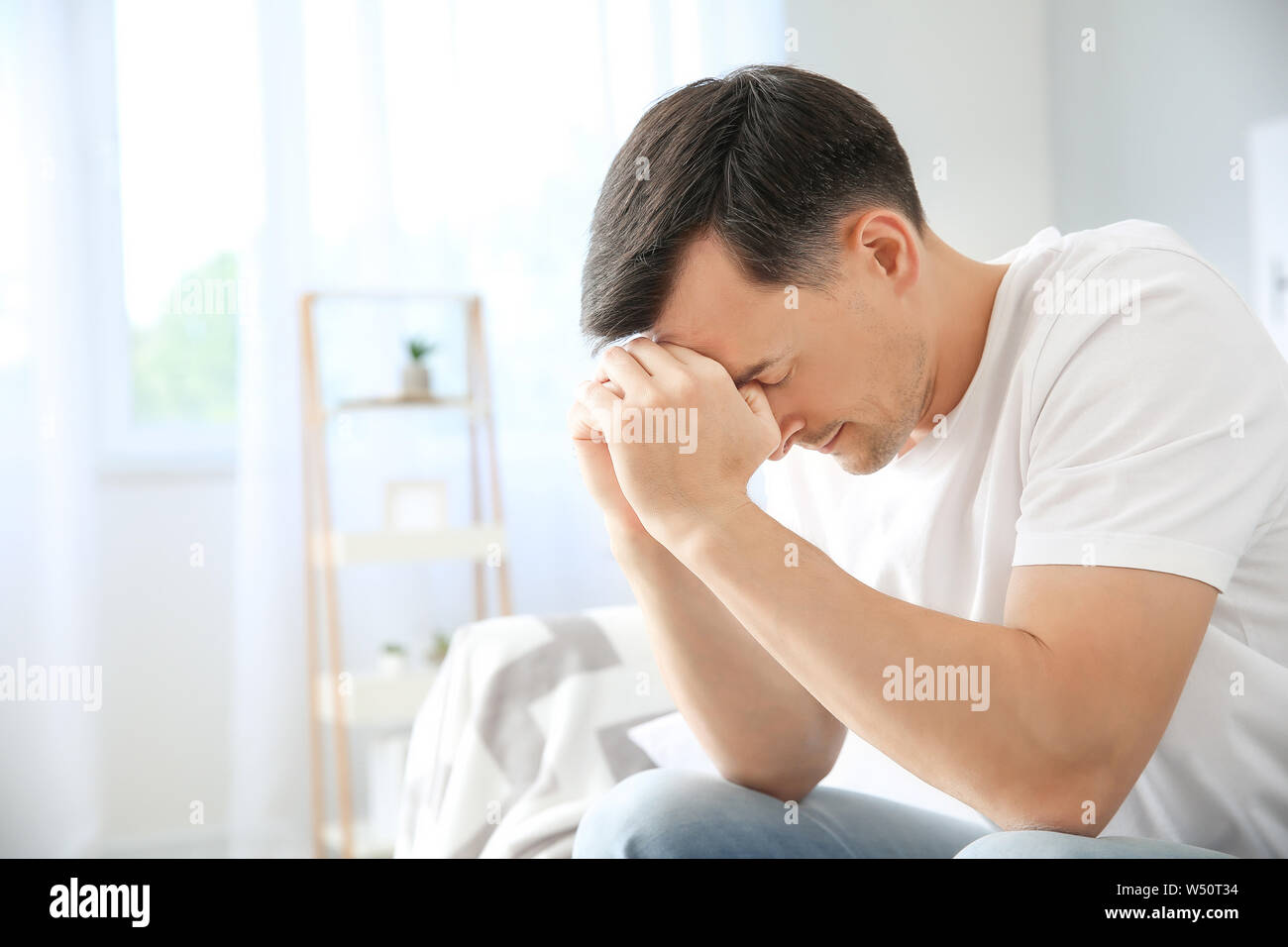 Religious man praying to God at home Stock Photo - Alamy