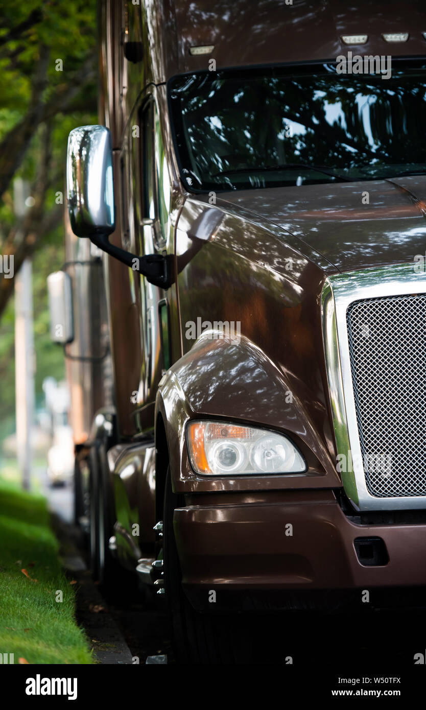 Classic shiny big rig bonnet dark brown semi truck tractor standing in ...
