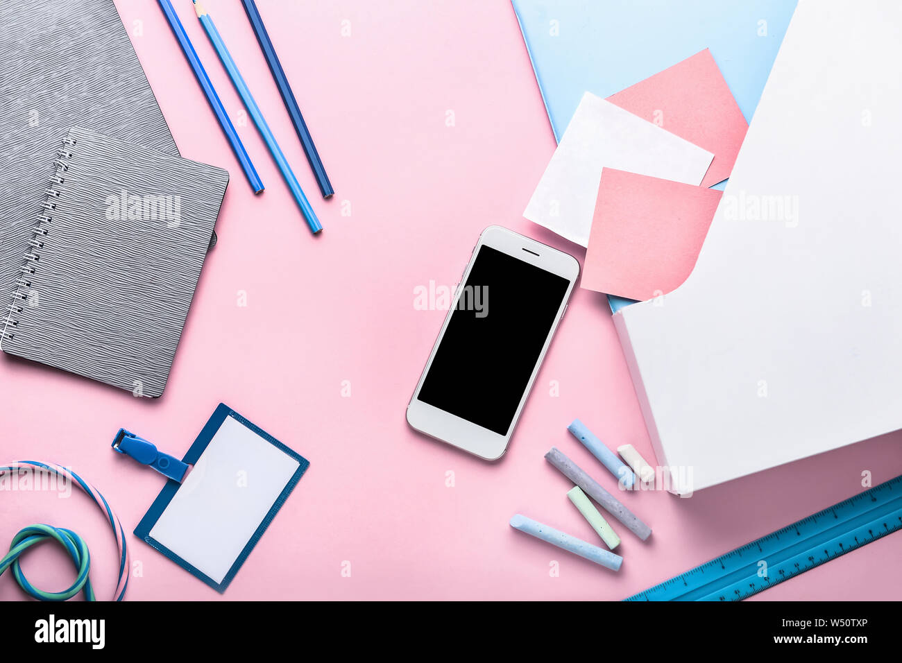 Mobile phone with stationery on color background Stock Photo - Alamy