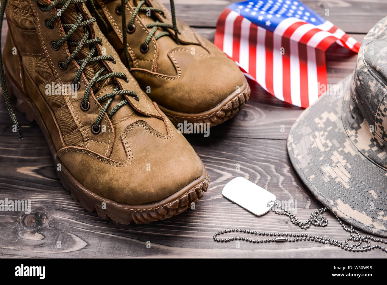 Military boots, USA flag, cap and dog tag on wooden background Stock ...