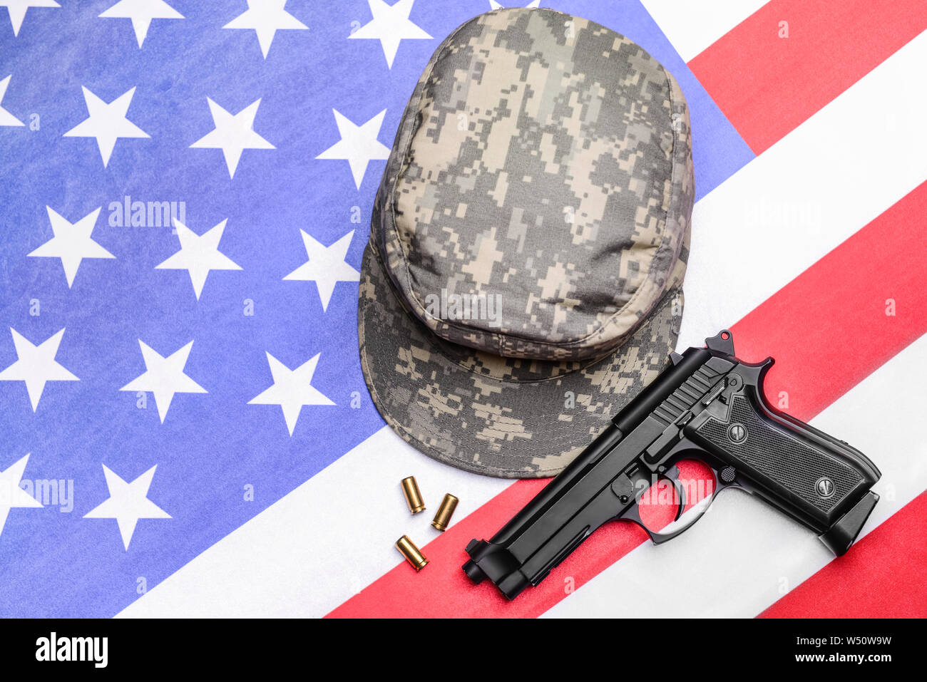 Military cap and gun on USA flag Stock Photo - Alamy