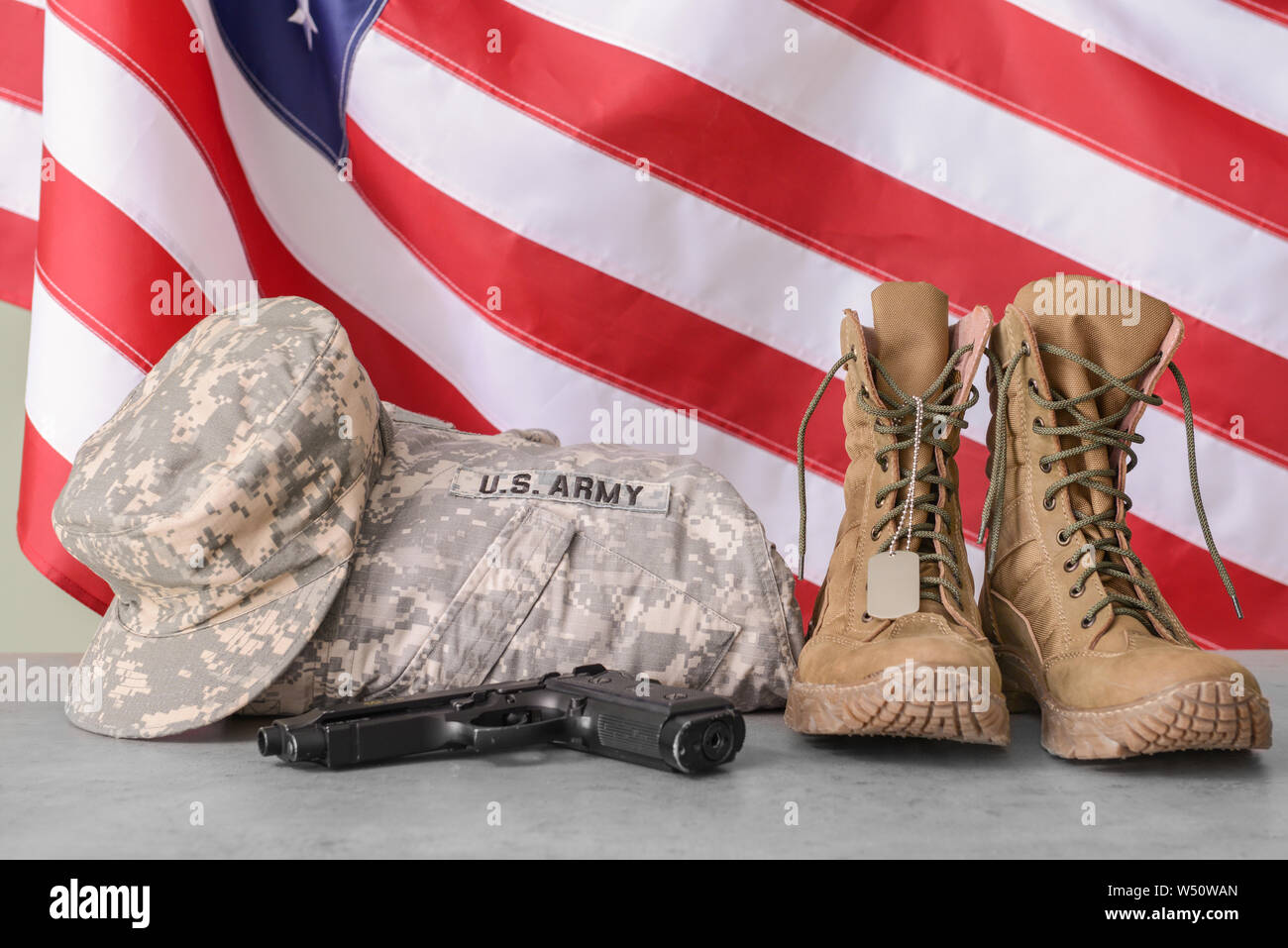 Military uniform and gun on table against USA flag Stock Photo - Alamy