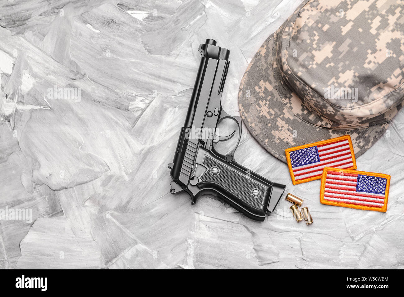 Military cap, gun and chevrons on grey background Stock Photo - Alamy