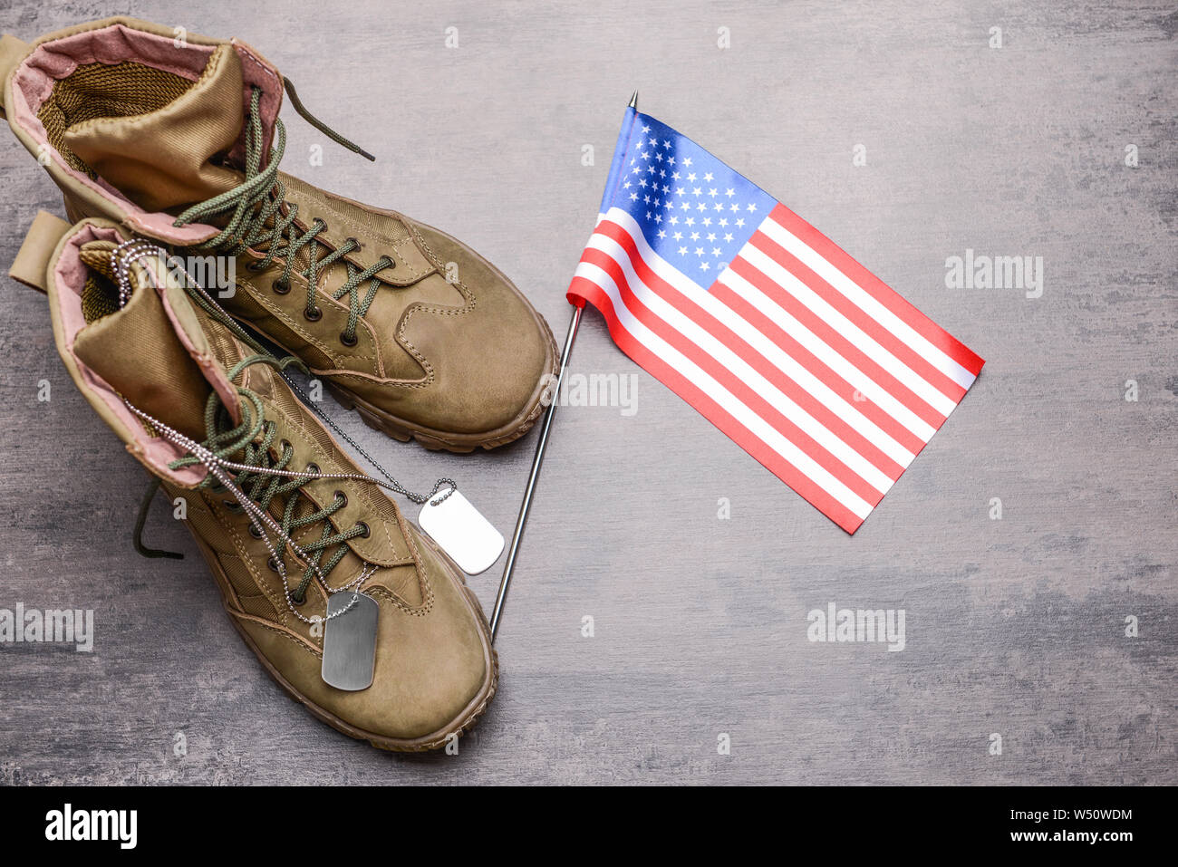 Military boots, USA flag and dog tag on grey background Stock Photo - Alamy