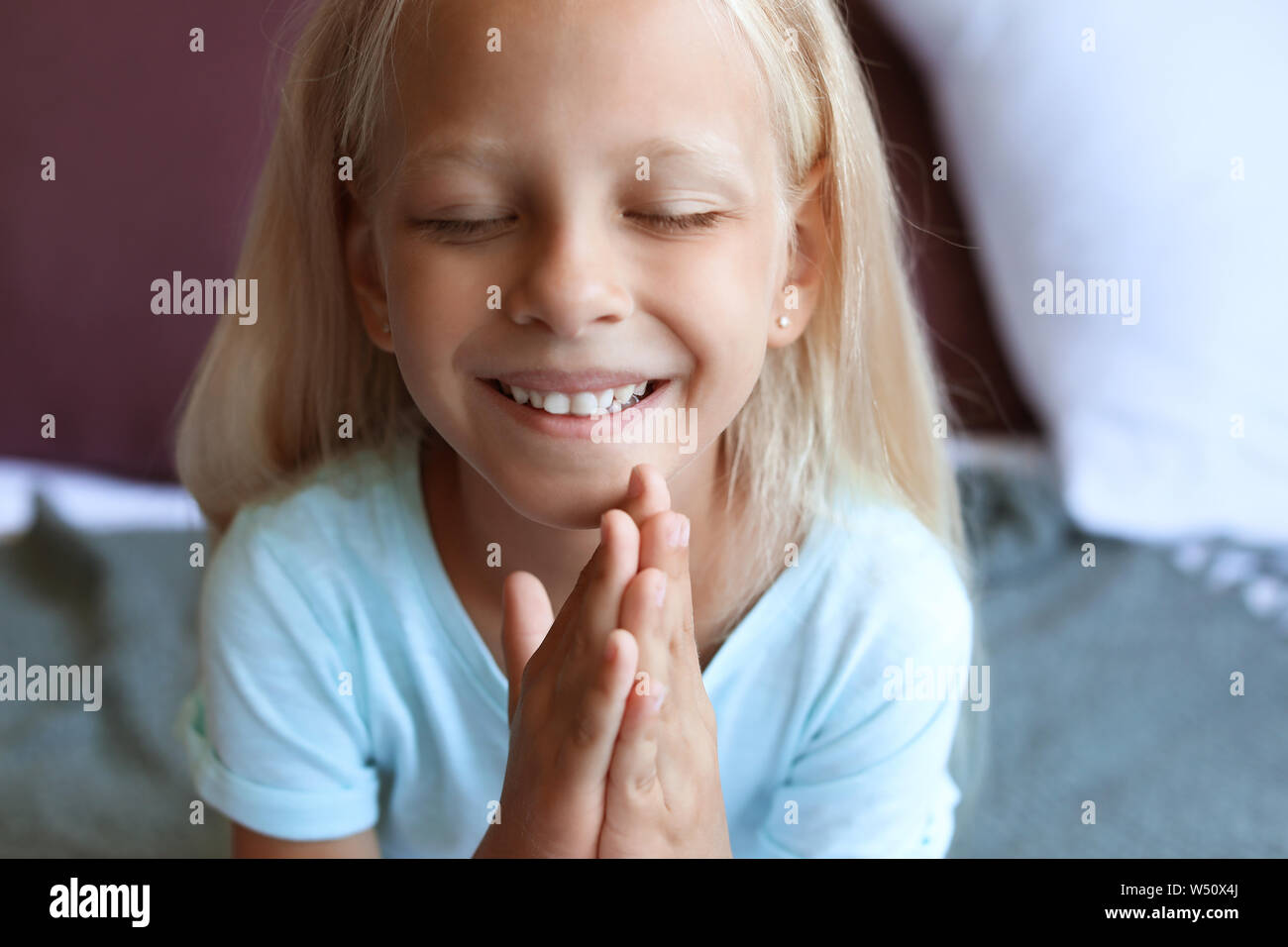 Little girl praying at home Stock Photo - Alamy