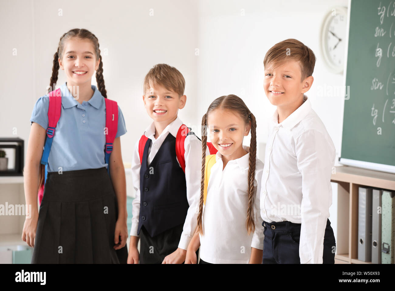 Cute little pupils in classroom Stock Photo - Alamy