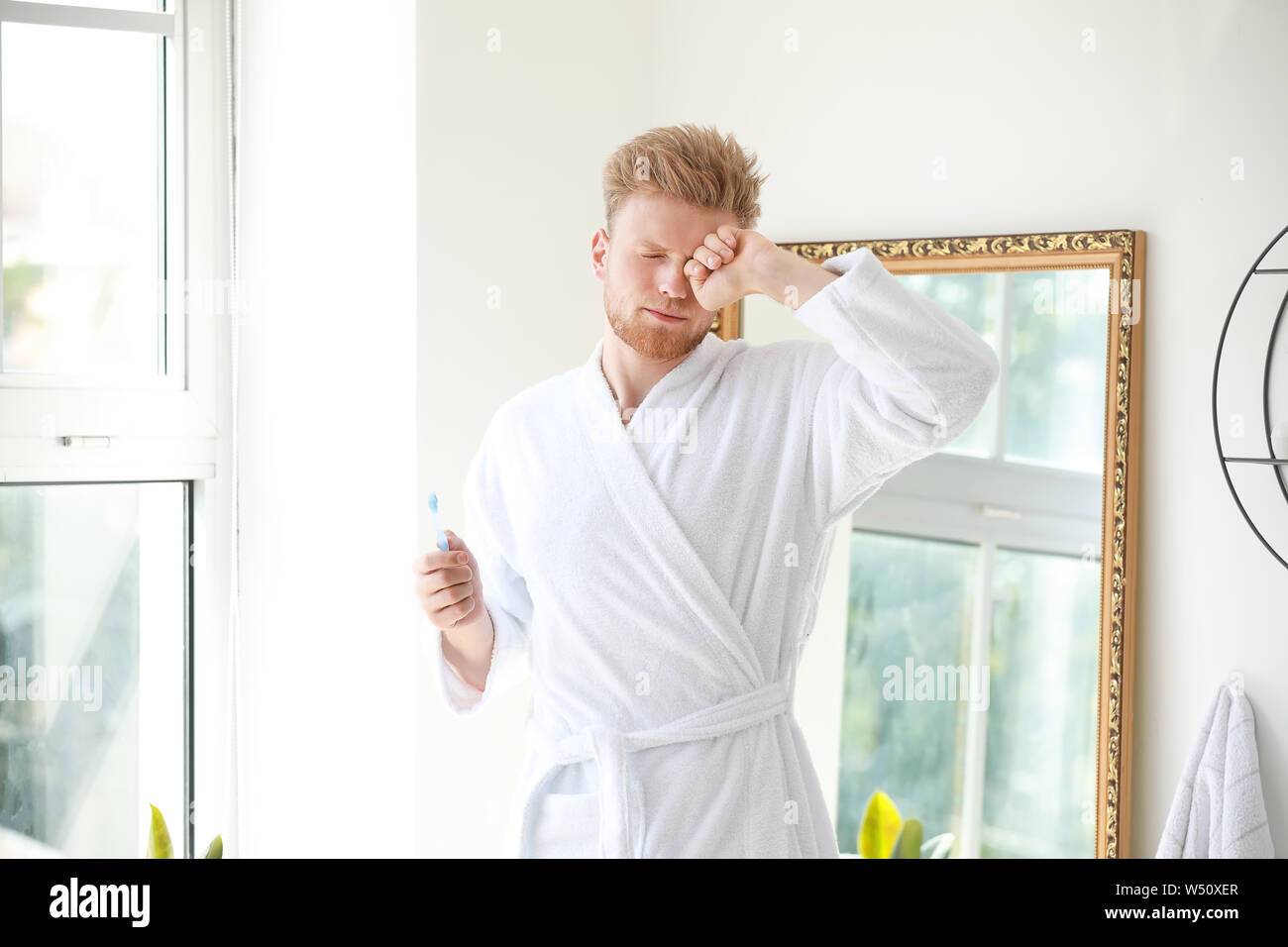 Man brushing teeth sleepy hi-res stock photography and images - Alamy