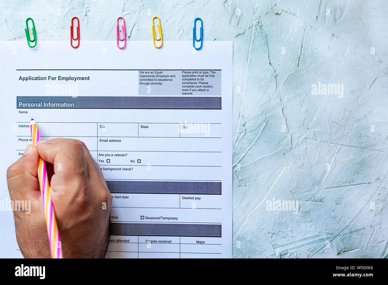 Hand filling Standard Application for Employment. HR, Hiring, Applicant ...