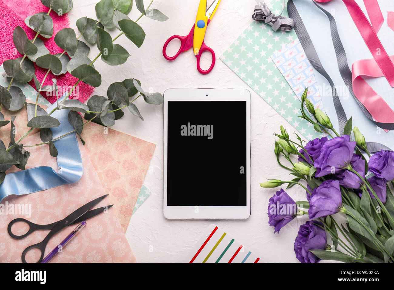 Modern tablet computer and accessories on workplace of florist Stock ...