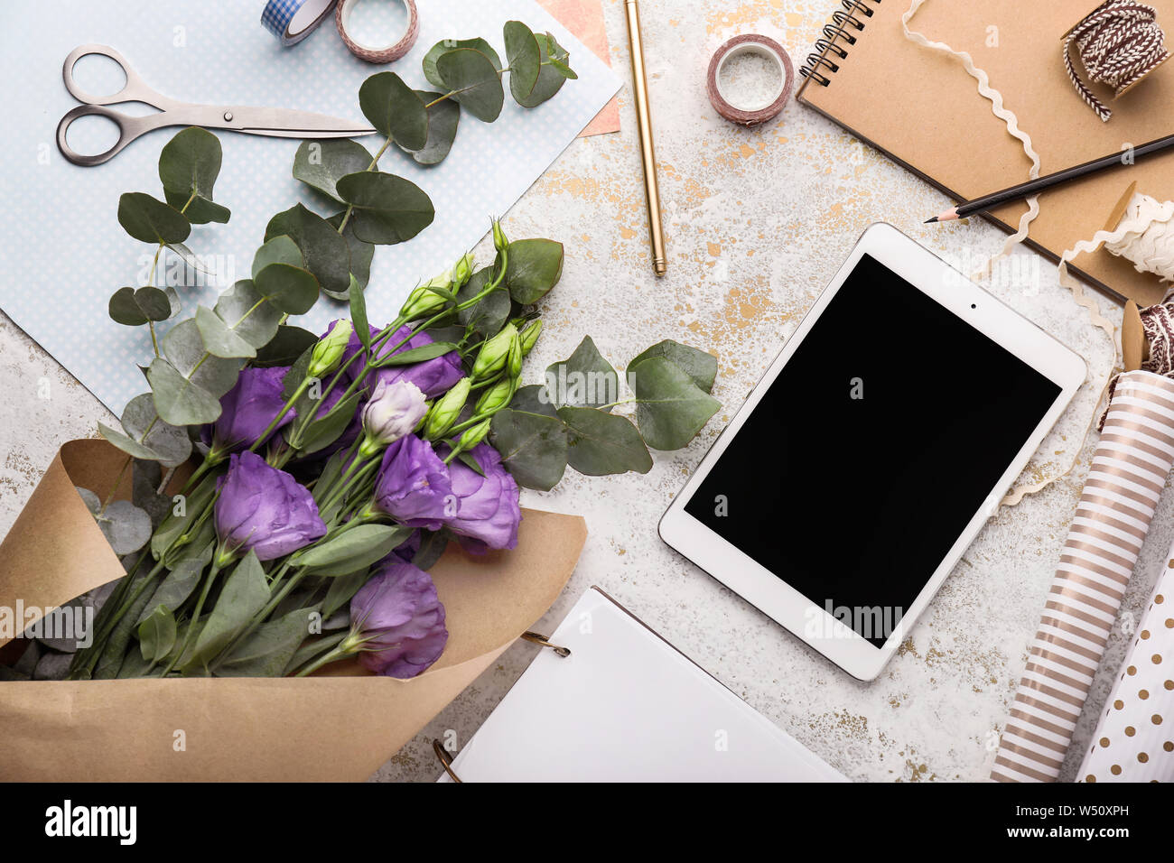 Modern tablet computer and accessories on workplace of florist Stock ...