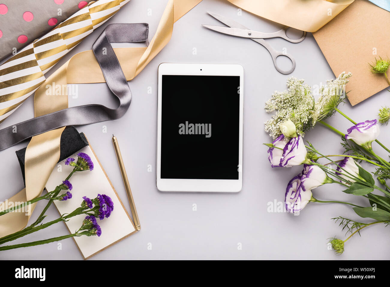 Modern tablet computer and accessories on workplace of florist Stock ...
